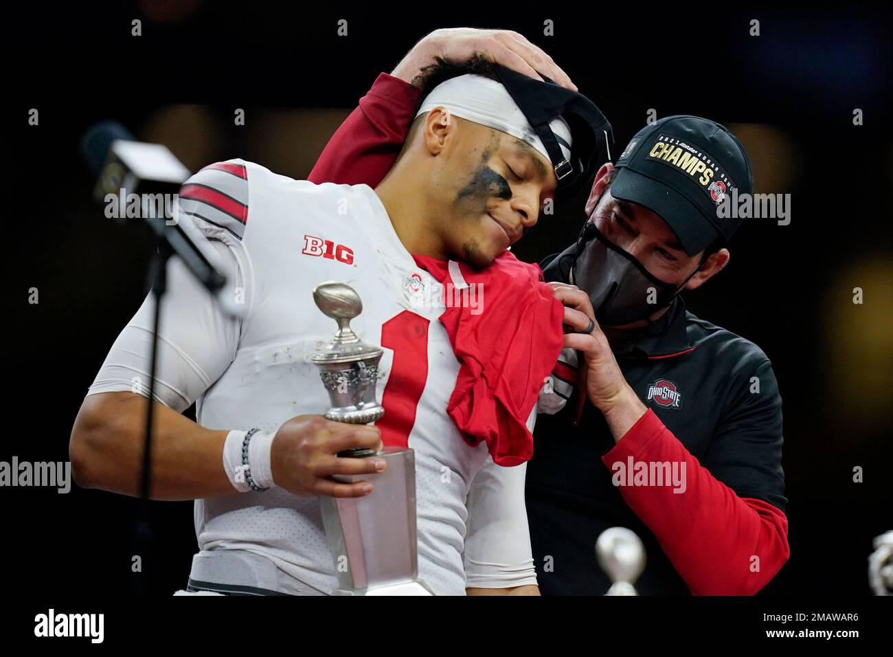 FILE - Ohio State head coach Ryan Day hugs quarterback Justin Fields ...