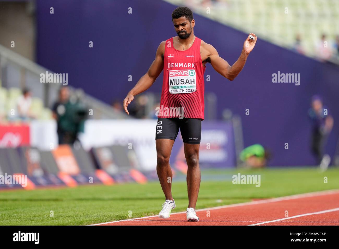 Kojo Musah, of Denmark, reacts after failing to finish a Men's 100 ...