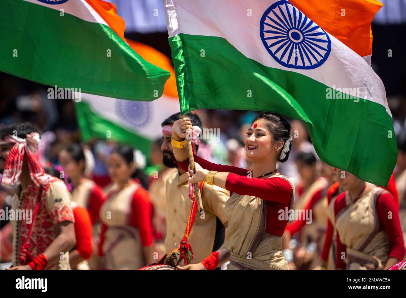 Assamese girls and boys in traditional attire carry Indian flags as ...