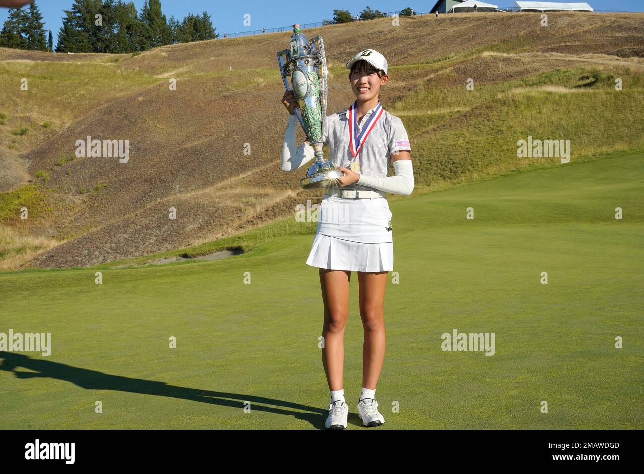 Saki Baba, of Japan, poses for photos with the trophy after she won the ...