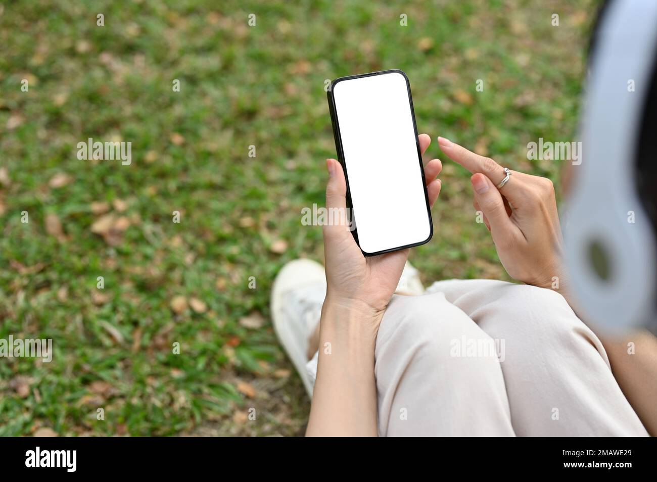 Young Asian woman in casual clothes wearing wireless headphones and ...