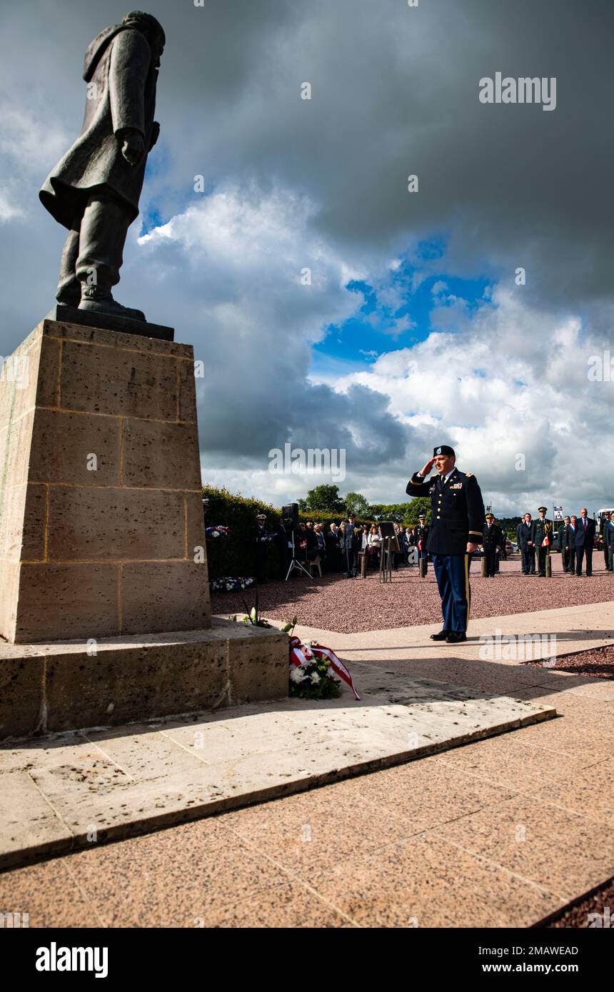A U.S. Army Soldier salutes a memorial to Danish seamen who were ...