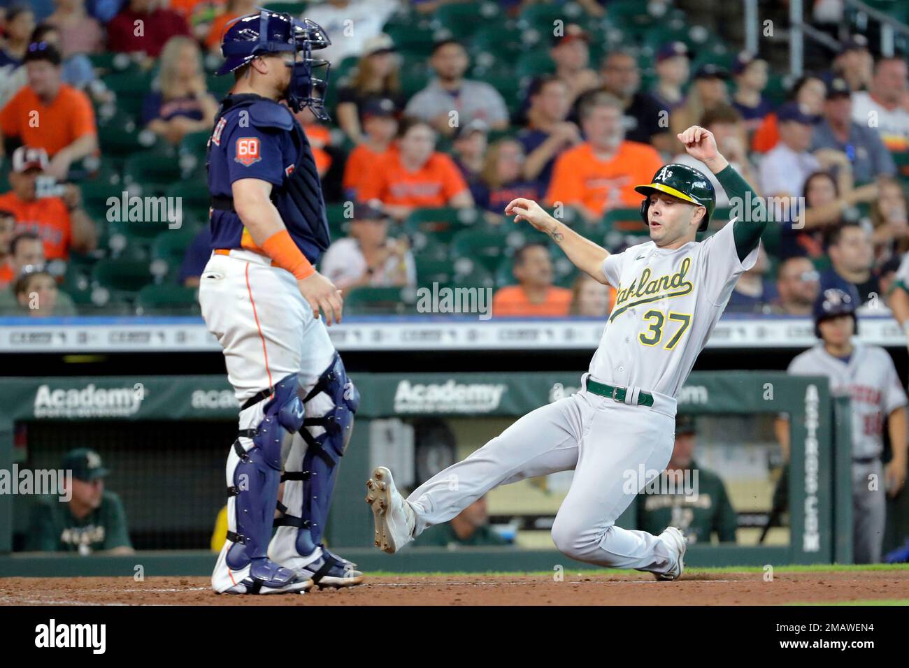 Oakland Athletics runner Cal Stevenson (37) slides into home plate in ...