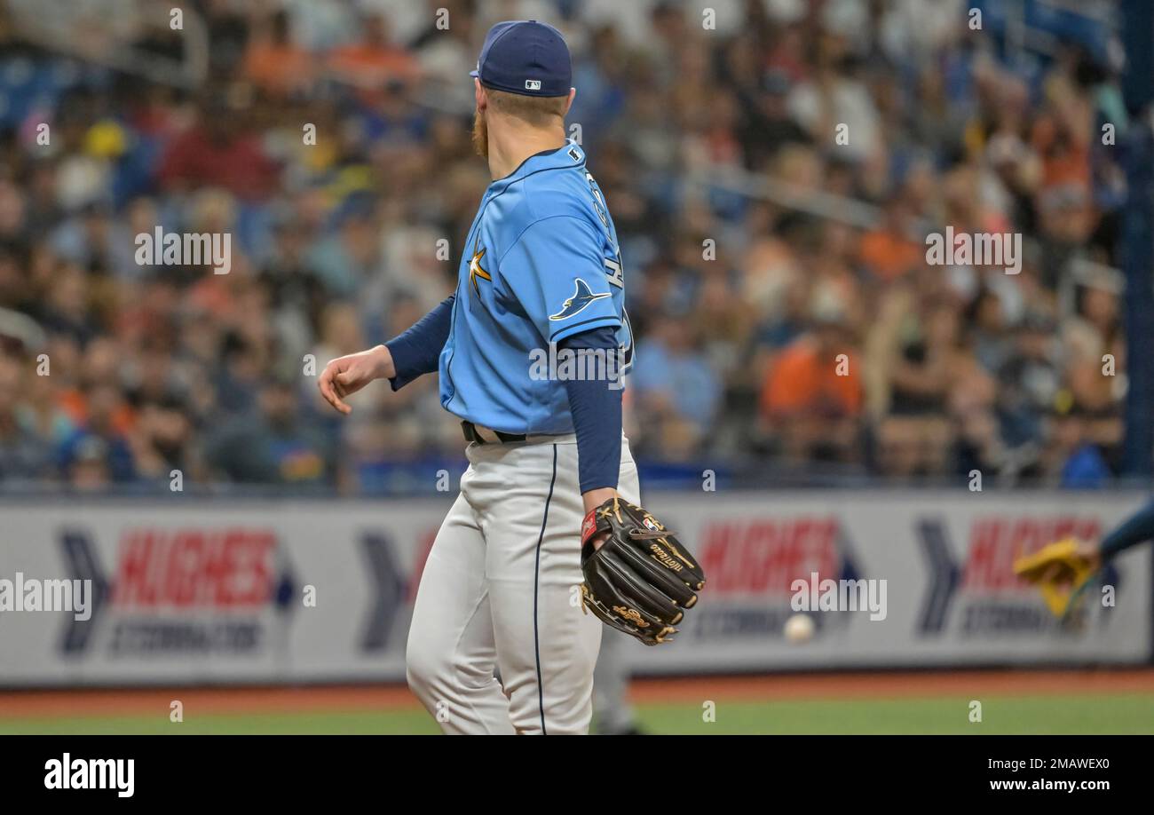 Tampa Bay Rays starter Drew Rasmussen looks over his shoulder at ...