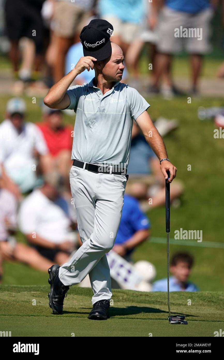Brian Harman waits to putt on the 18th green during the final round of ...
