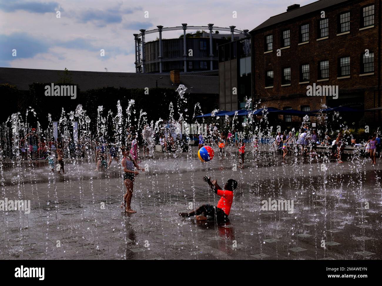 A child plays in a fountain to beat the heat in London, Sunday, Aug.14 ...