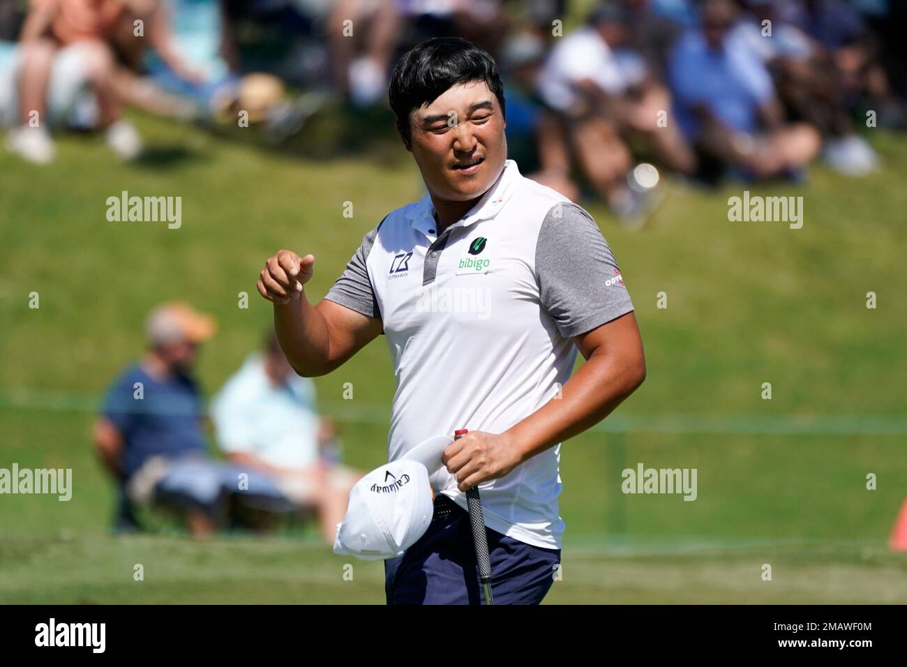 K.H. Lee, of South Korea, walks off the 18th green after finishing his ...