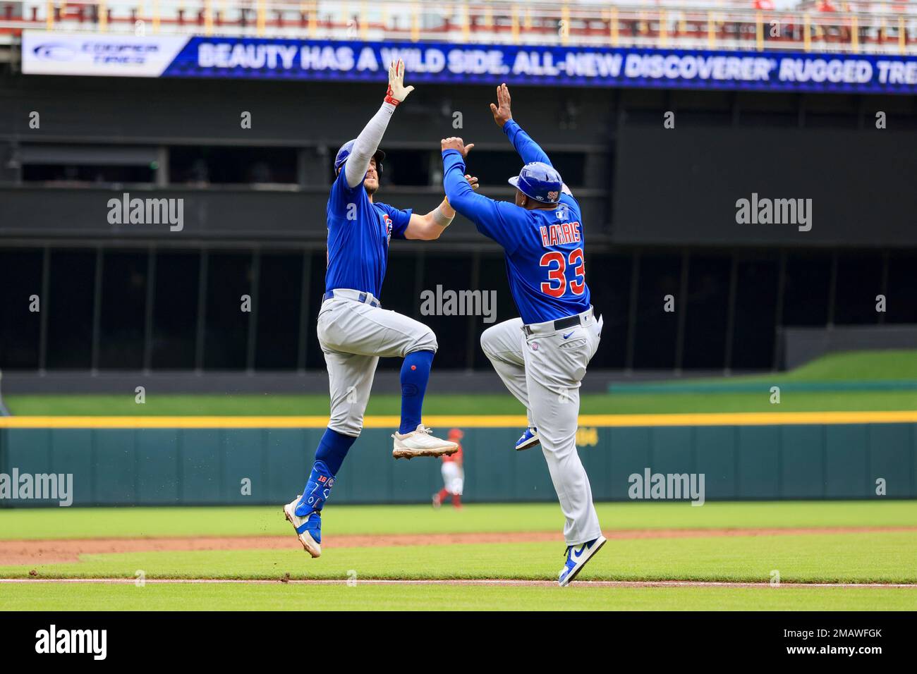 Chicago Cubs' Patrick Wisdom, left, jumps to high-five Willie Harris ...