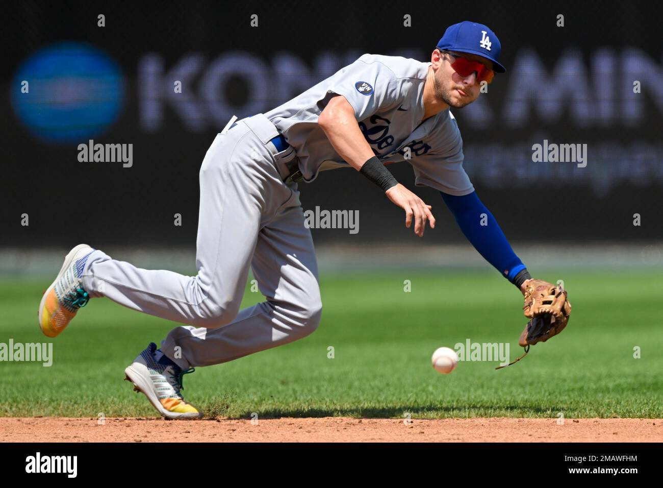 Los Angeles Dodgers shortstop Trea Turner is unable to run down a single off the bat of the ...