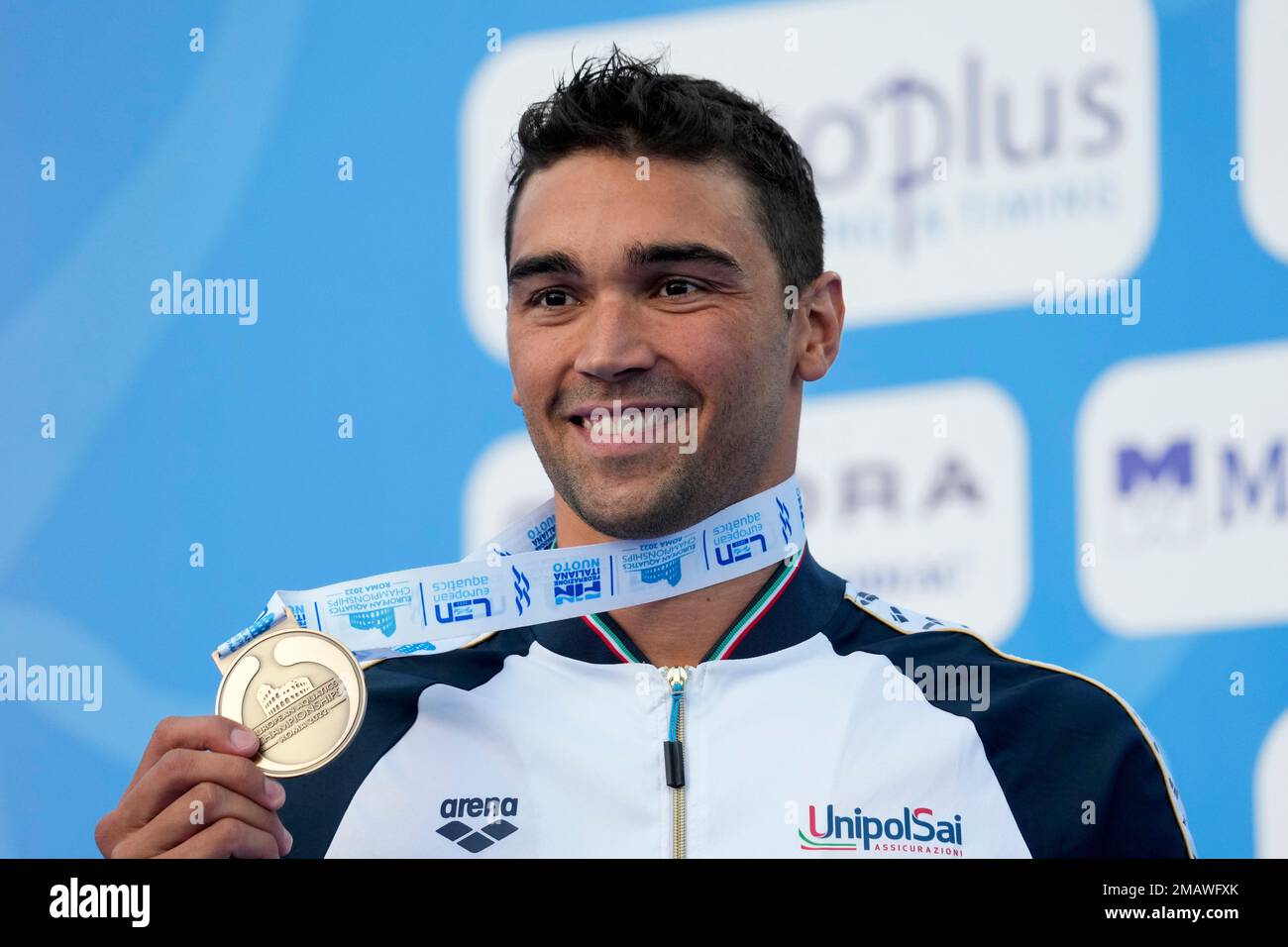 Italy's Luca Pizzini celebrates on the podium after winning a bronze ...