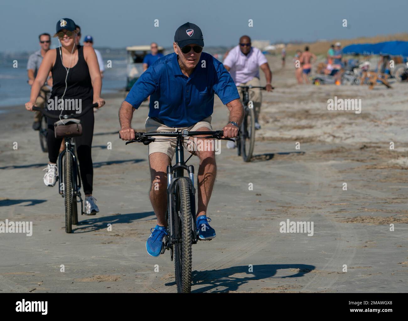 President Joe Biden rides a bicycle along the beach at Kiawah Island, S ...