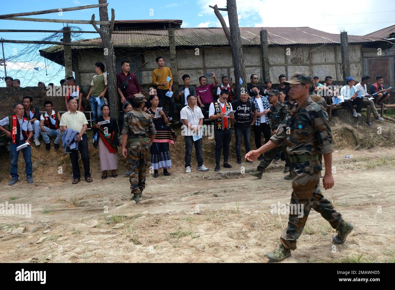 A Naga Army soldier walks past people participating in celebrations ...