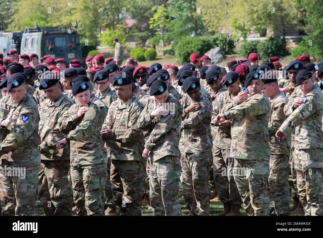 Soldiers place their new Arctic Angels patches on their left shoulders ...