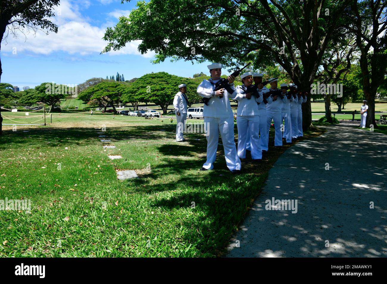 The Navy Region Hawaii Firing Team conduct a 21-gun salute during an ...