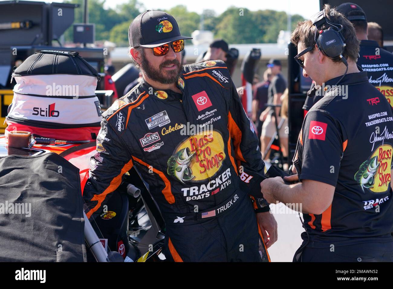 Martin Truex Jr., left, talks with a crew member prior to practice and ...