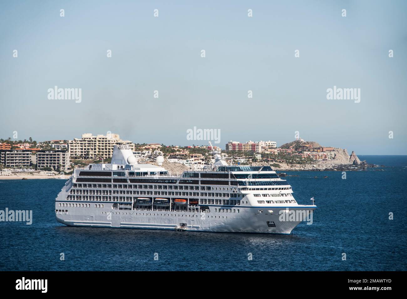 A cruise ship lays at anchor in the port of Cabo San Lucas, Mexican ...