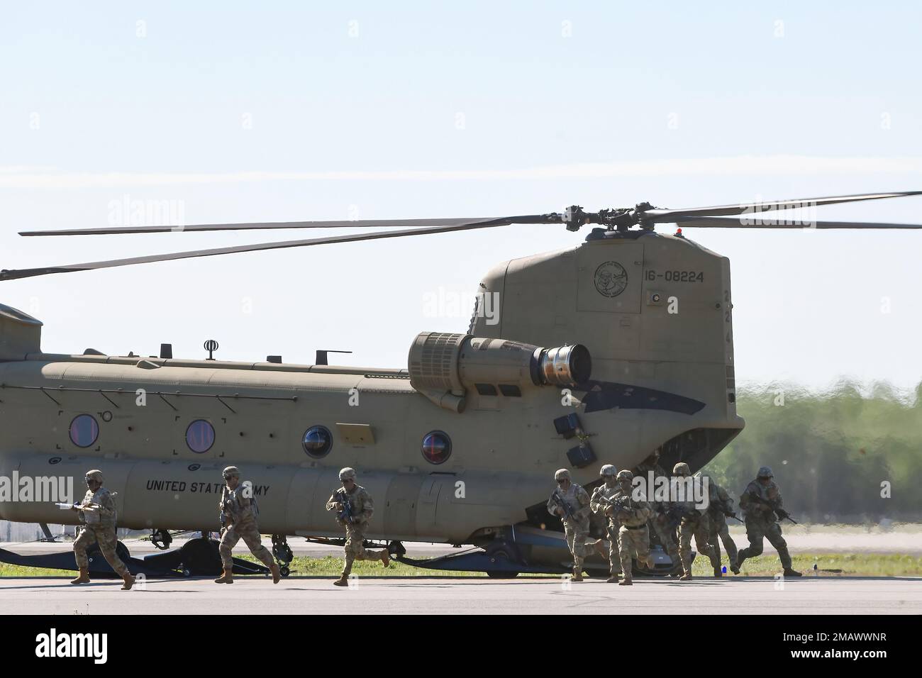 Soldiers exit a CH-47 Chinook helicopter during an air assault mission ...