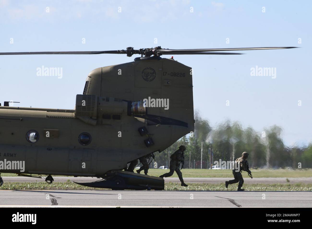 Soldiers exit a CH-47 Chinook helicopter during an air assault mission ...