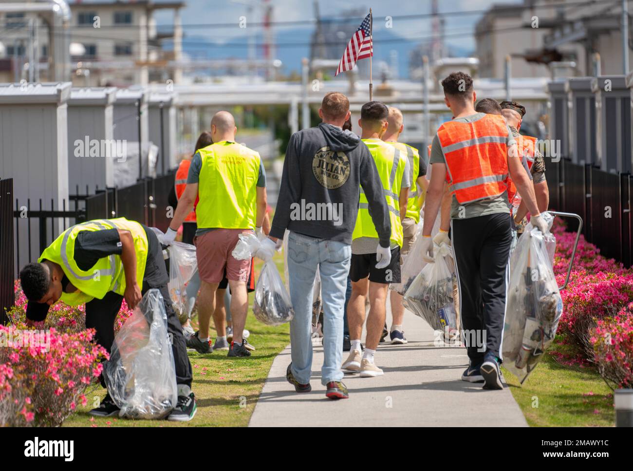 U.S. Marines gather trash during an on-base cleanup organized by the ...