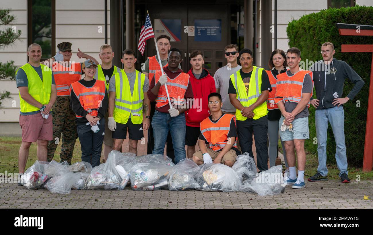 U.S. Marines and Sailors pose for a photo during an on-base cleanup ...
