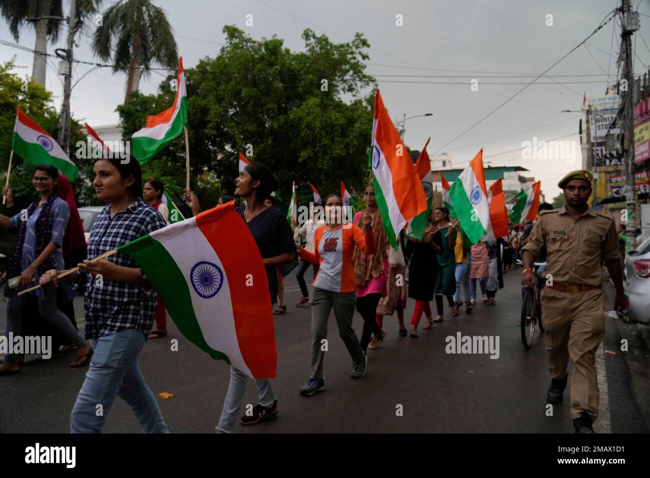 People hold Indian national flags and walk in a 'Tiranga rally', or ...