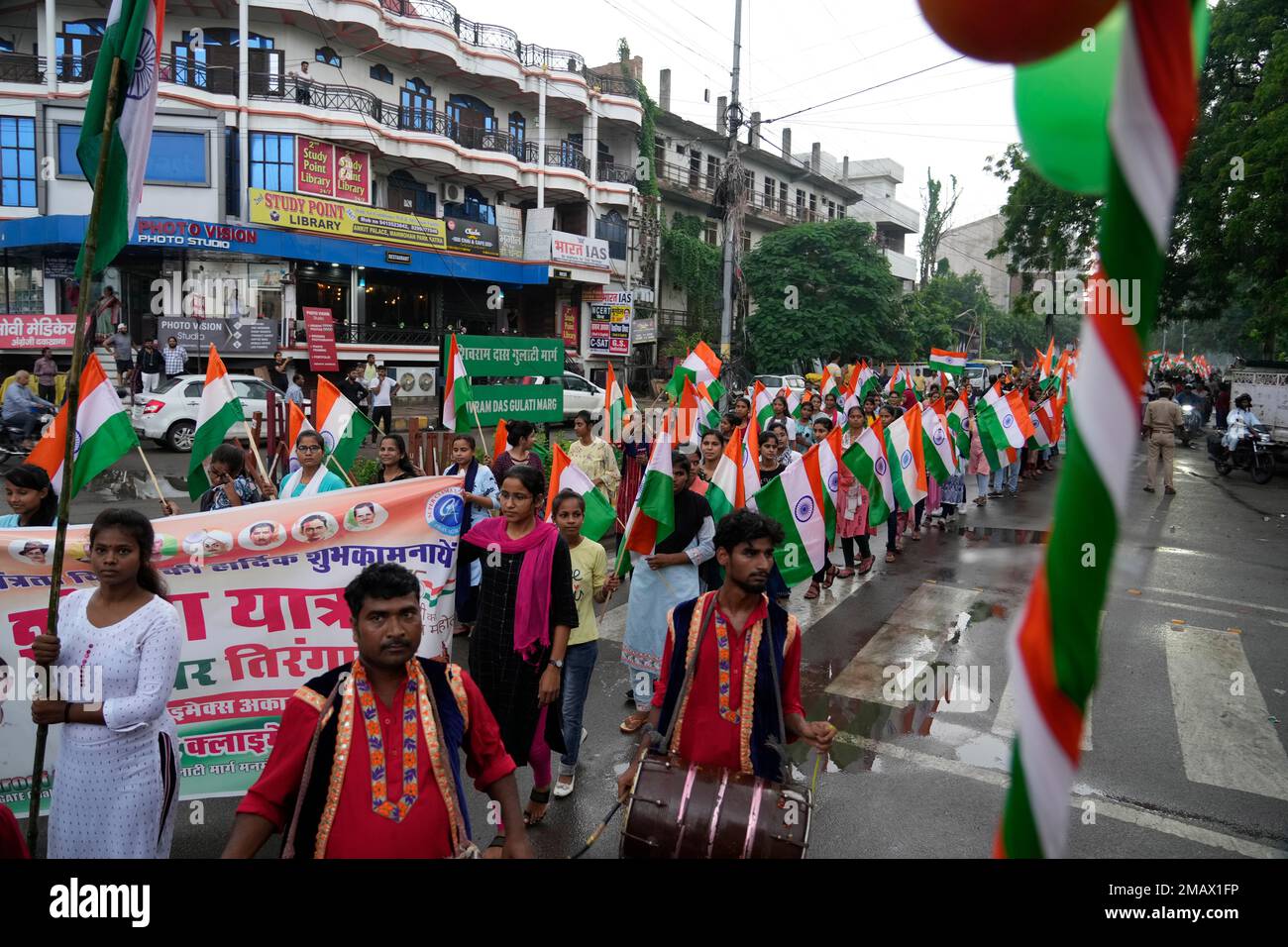 People hold Indian national flags and walk in a 'Tiranga rally', or ...