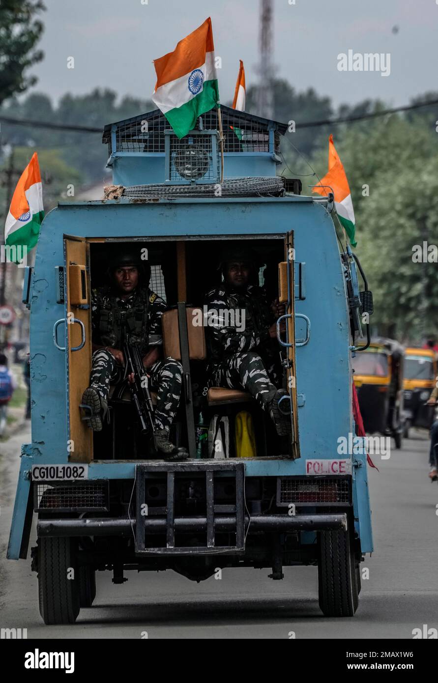 Indian paramilitary soldiers patrol in an armoured vehicle displaying ...