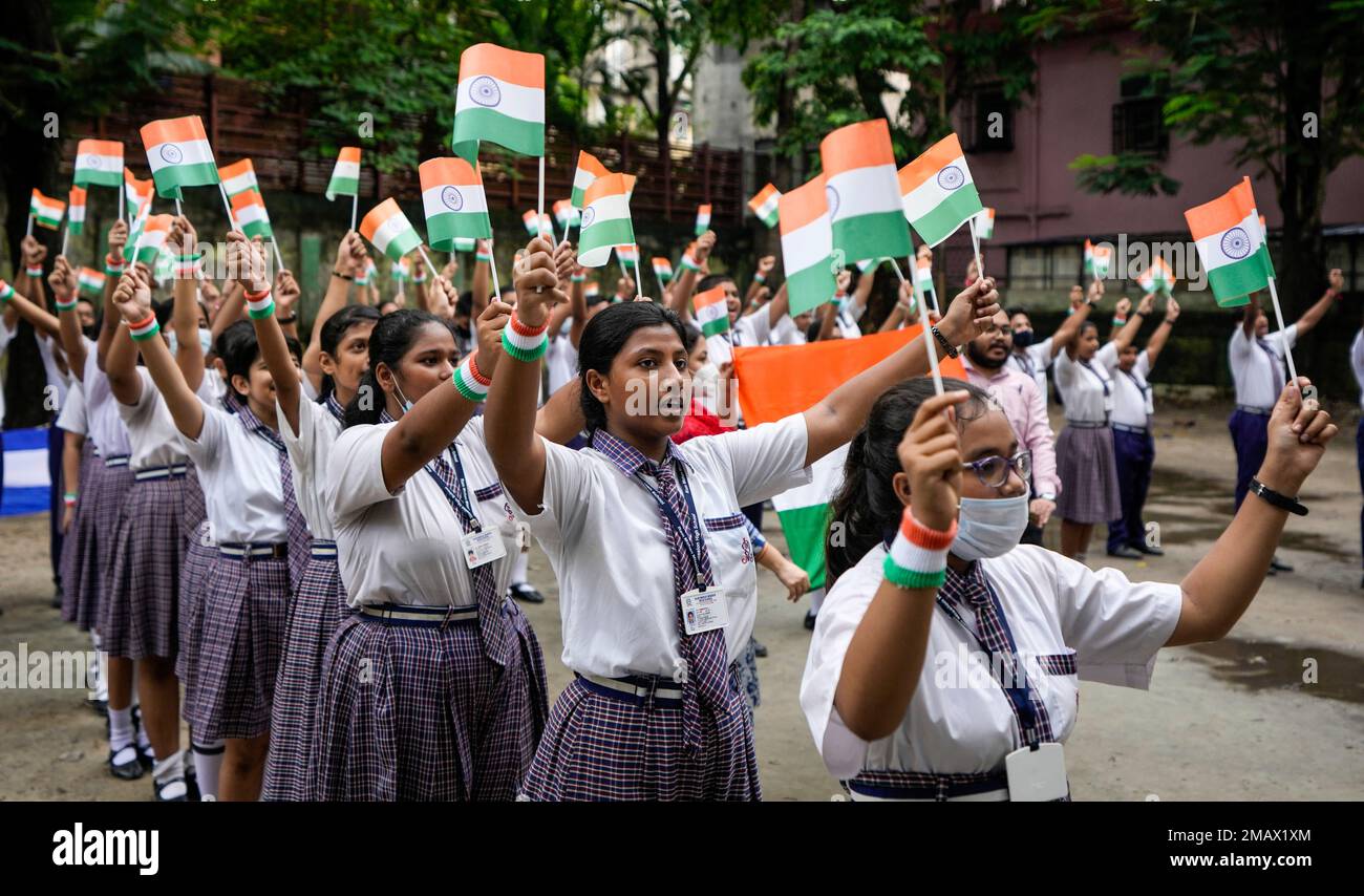 School students wave the Indian tricolor flag during preparations for ...