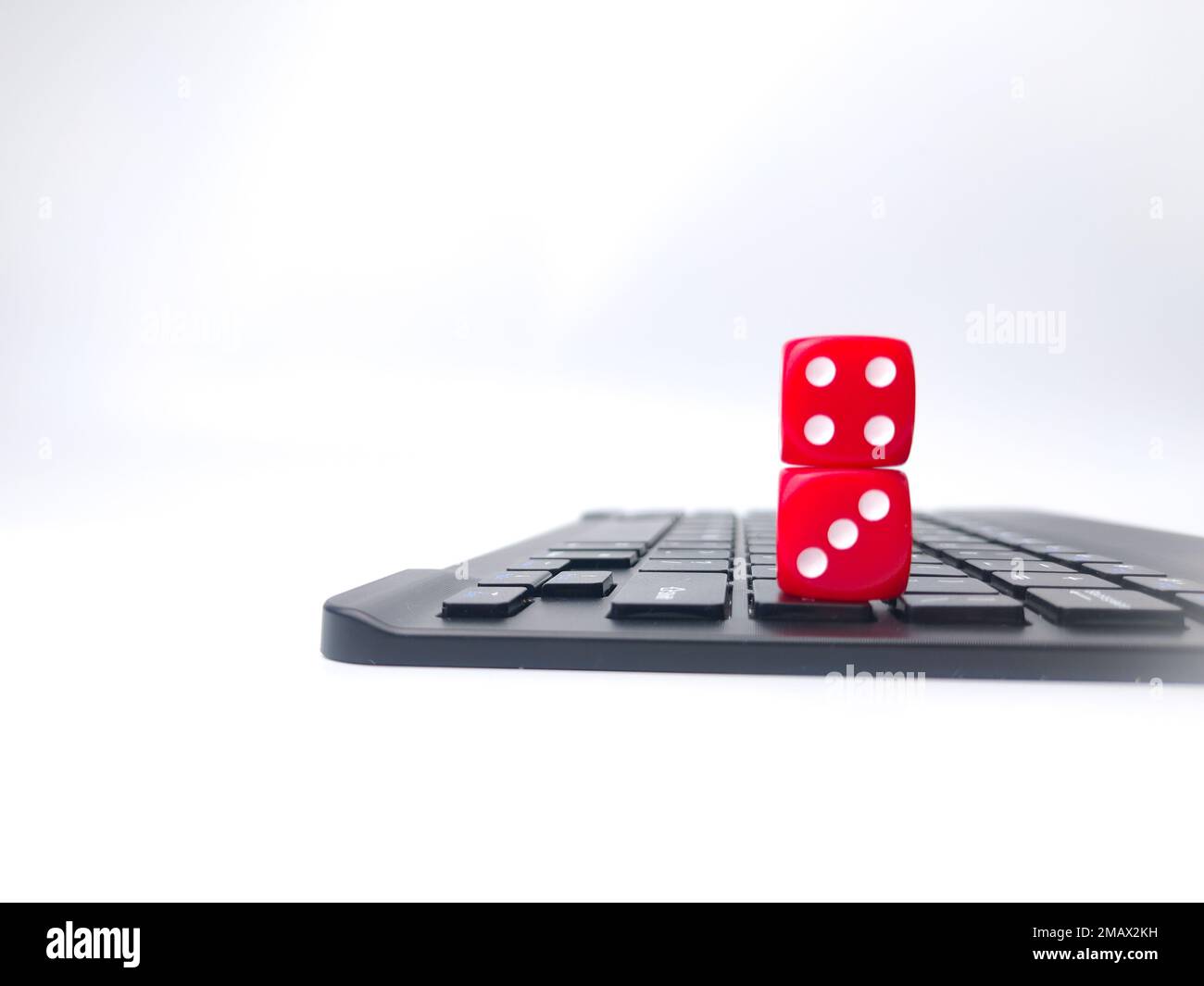 Red dice on keyboard.Playing dice for game online on computer keyboard ...