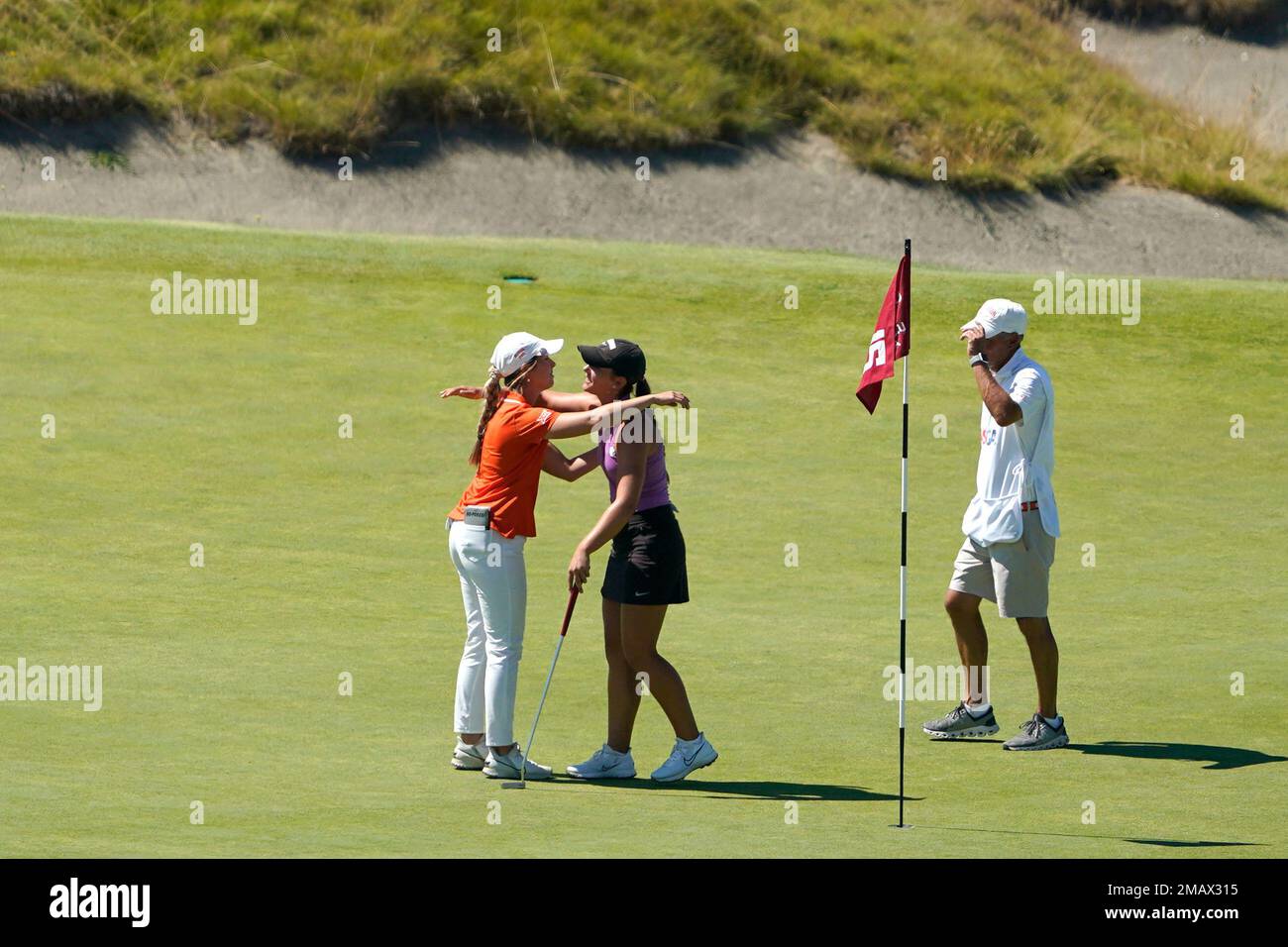 Annabelle Pancake, center, hugs Maddison Hinson-Tolchard, of Australia ...