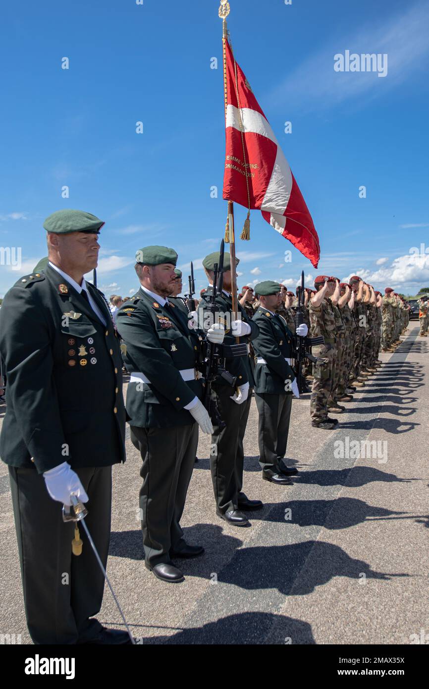 French service members and U.S. Army service members render a salute to ...