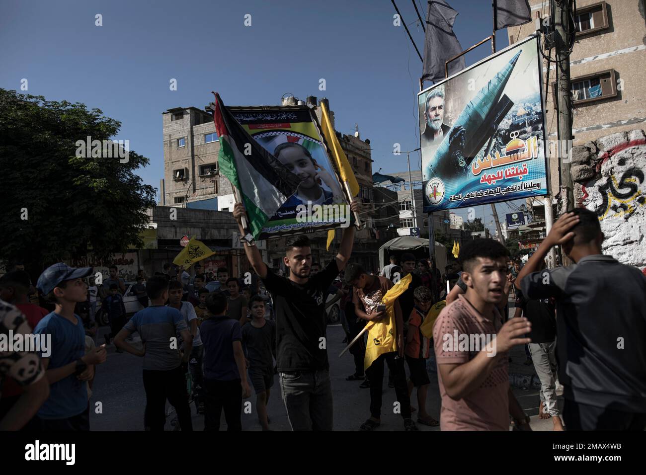 Mourners carry a photo of 11-year-old Layan al-Shaer during her funeral ...
