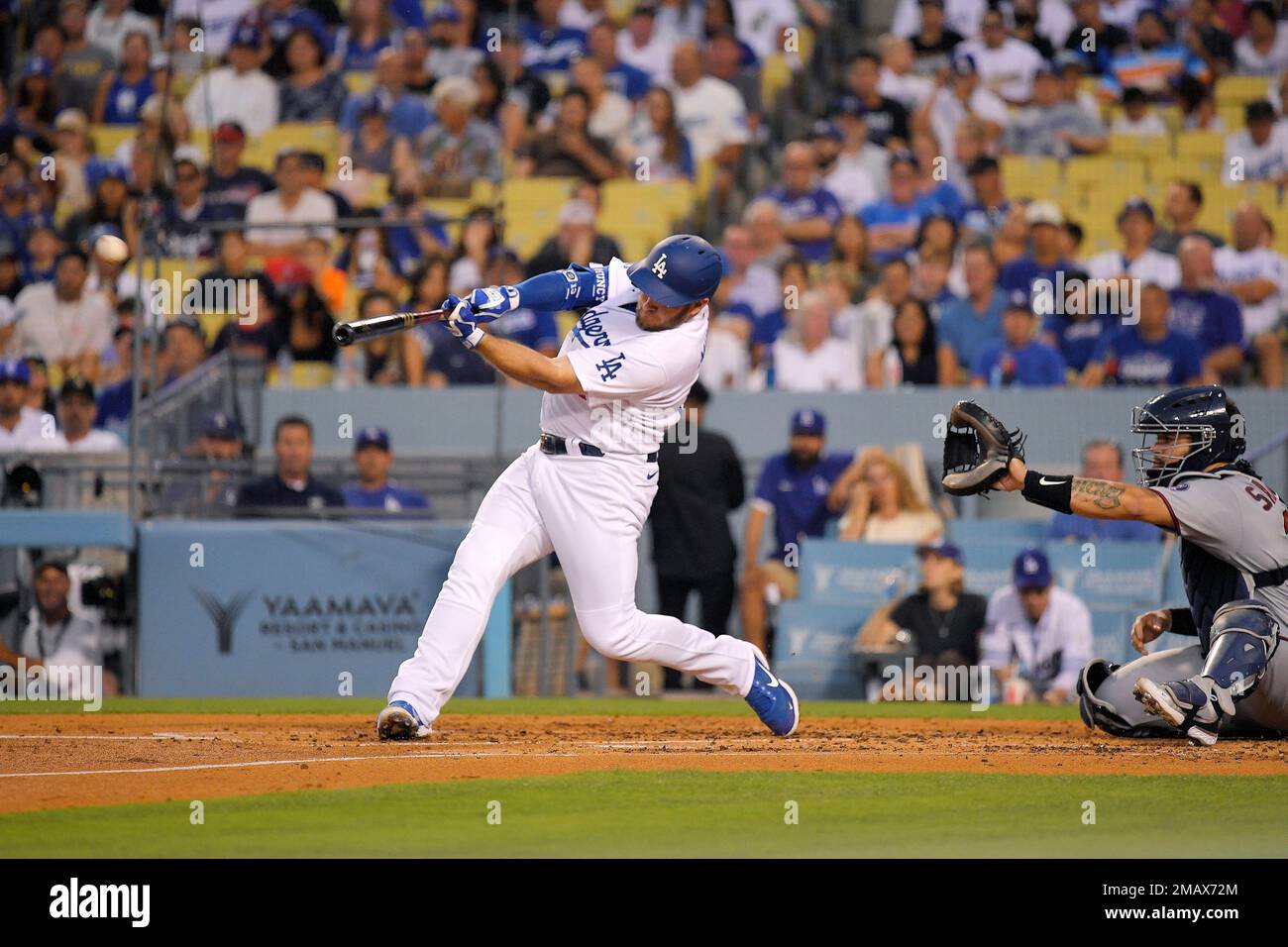 Los Angeles Dodgers' Max Muncy, left, hits a solo home run as Minnesota ...