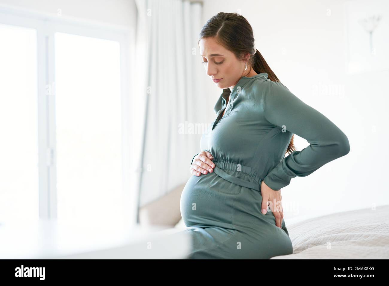 My belly has gotten so big. a young mother preparing for birth in her ...