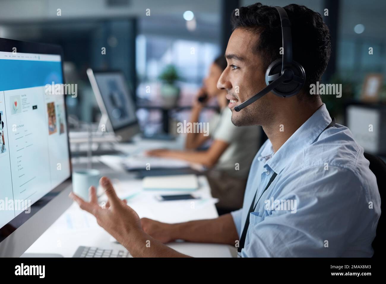 Theres no call he cant make work. a young man using a headset and ...