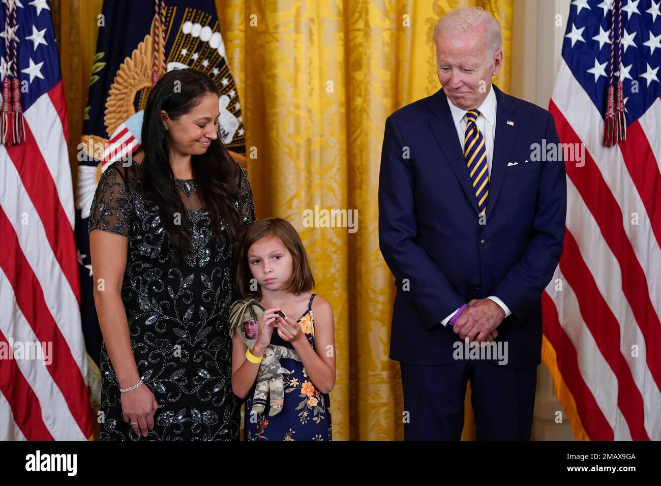 President Joe Biden looks to Danielle Robinson, wife of Sgt. 1st Class ...