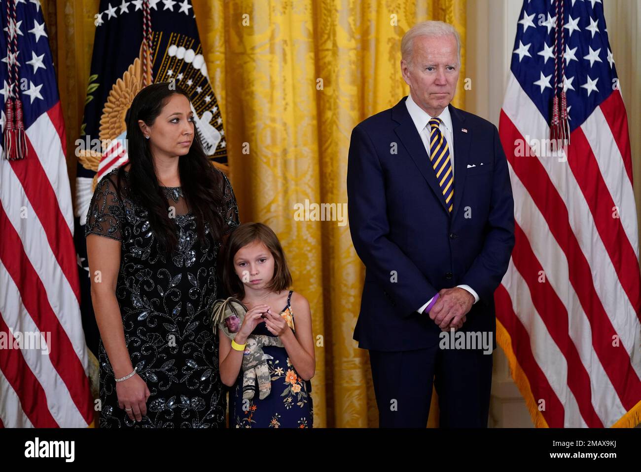 President Joe Biden looks to Danielle Robinson, wife of Sgt. 1st Class ...