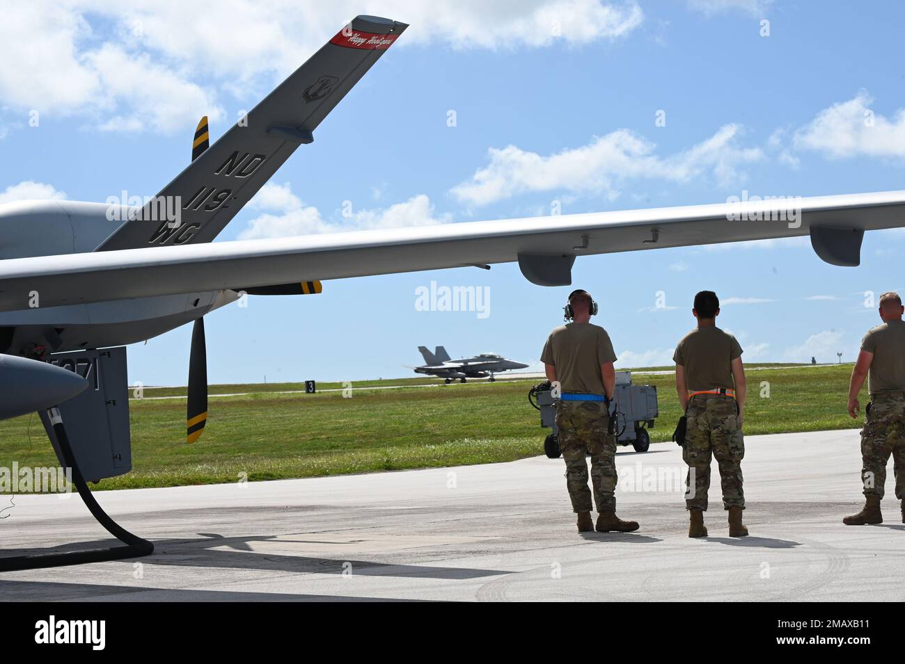 U.S. Air Force members of the 119th Maintenance Squadron watch an F-18 ...