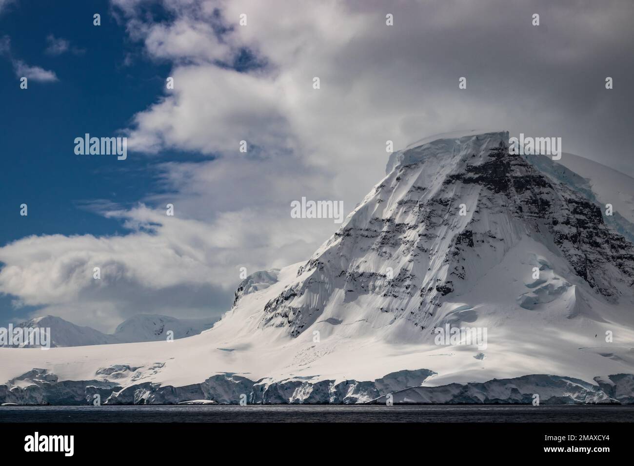 Steep mountain peak on Antarctic Peninsula. Peak covered with thick ...