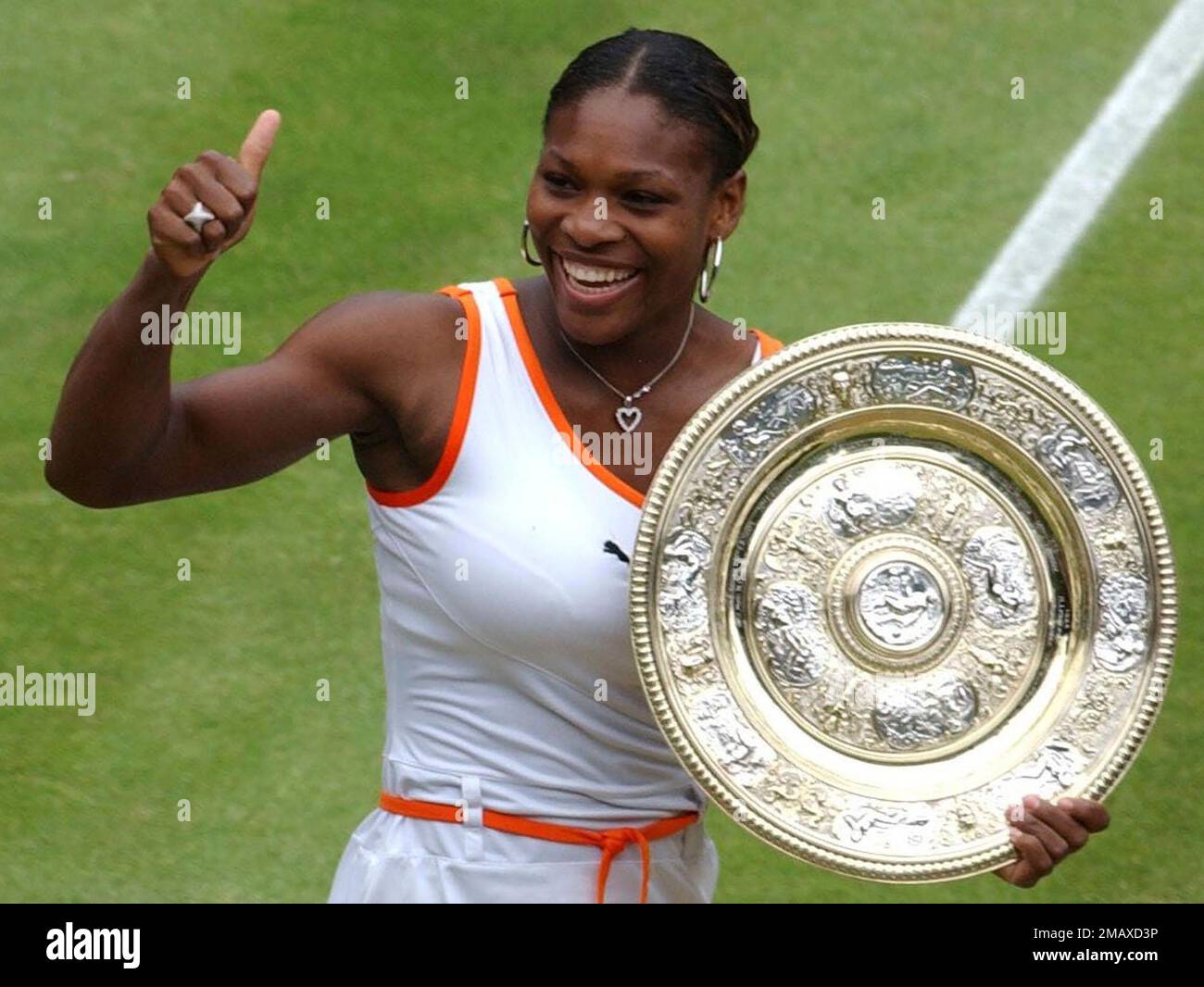 FILE - Serena Williams gives the thumbs up as she holds her trophy ...