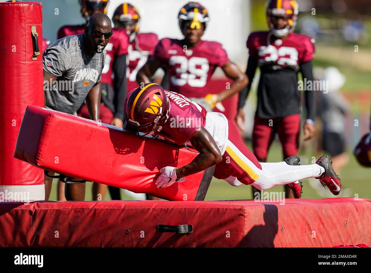 Washington Commanders safety Percy Butler (35) hits a tackling dummy ...