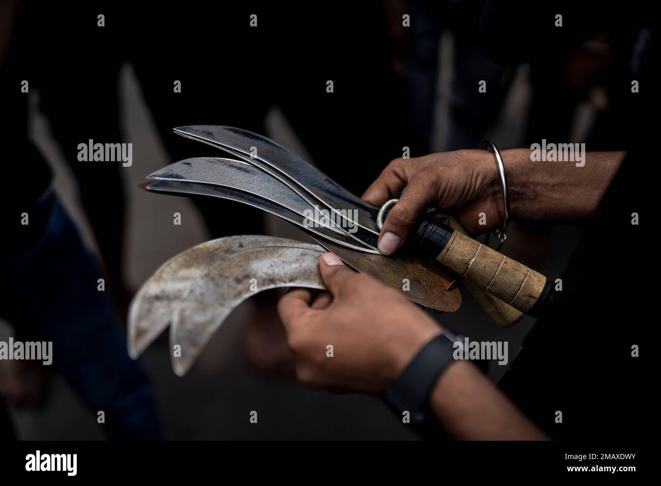 A Shiite Muslim holds his knives before flagellating himself during an Ashoura procession in New ...