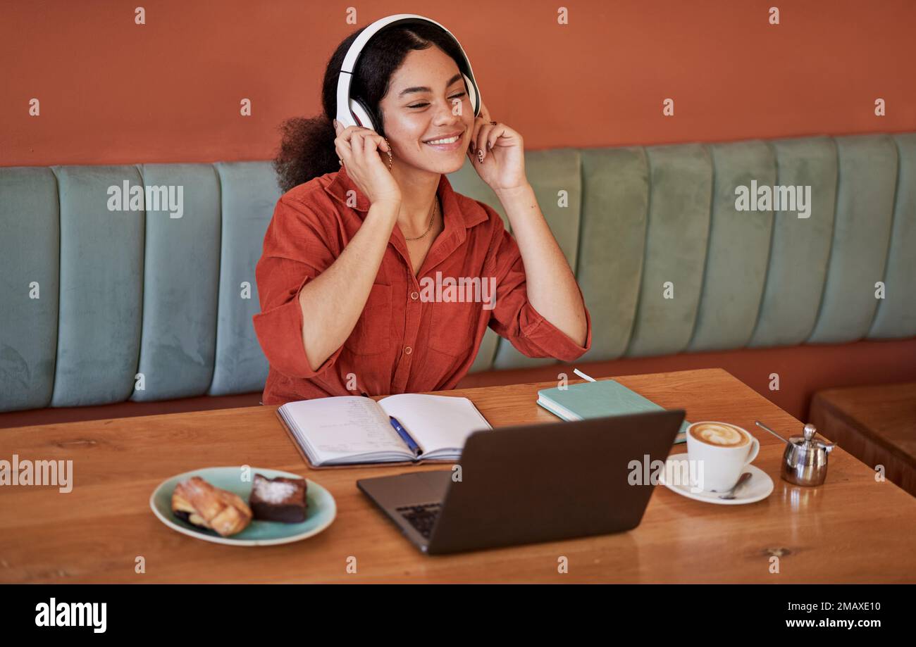 Headphone, cafe and black woman with music or web podcast working on a ...