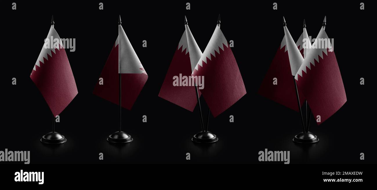 Small national flags of the Qatar on a black background Stock Photo - Alamy