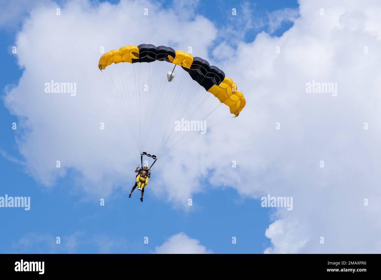 Staff Sgt. Daniel Osorio of the U.S. Army Parachute Team makes a tandem ...