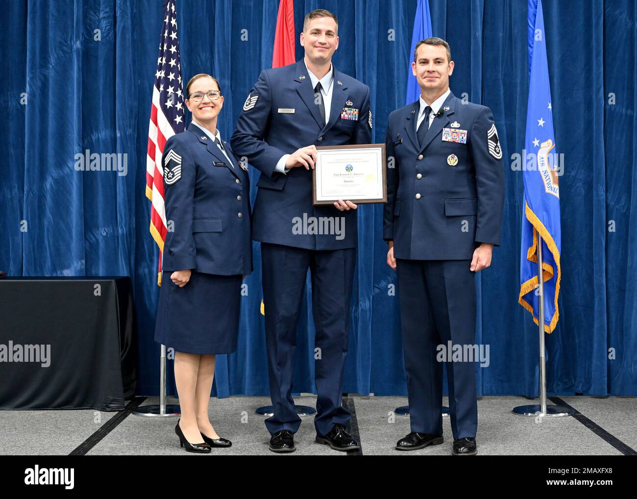 U.S. Air Force Tech. Sgt. Kenneth Barrows receives a Distinguished Graduate Award during the ...