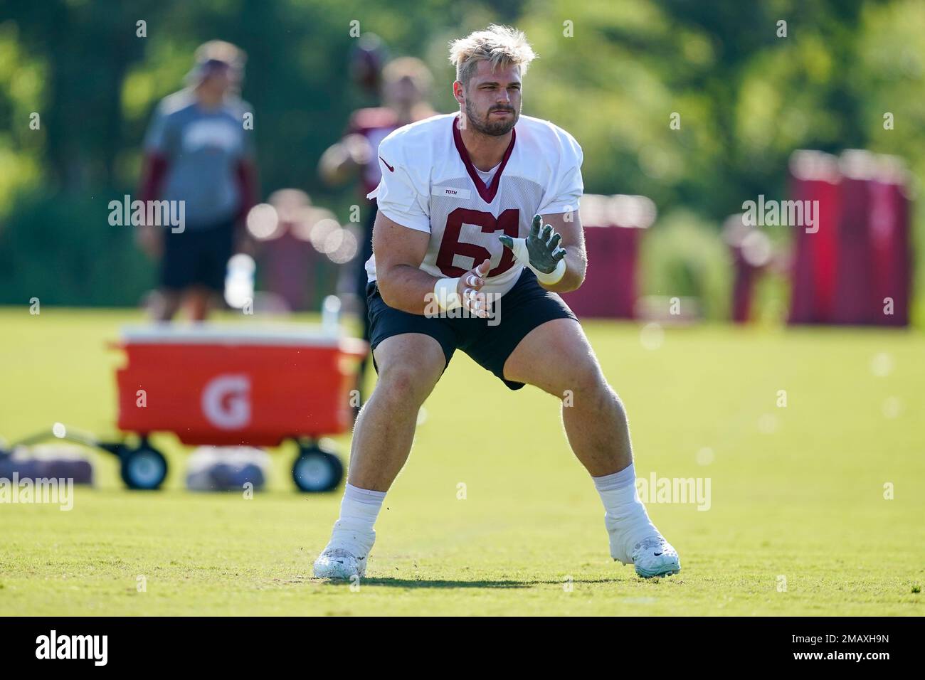 Washington Commanders center Jon Toth (61) runs a drill during practice ...