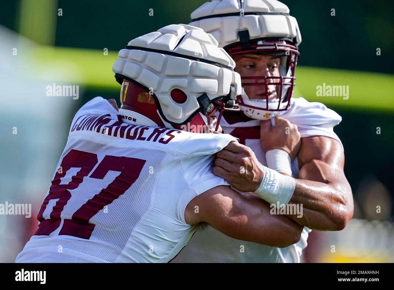 Washington Commanders tight end John Bates, left, works against tight ...