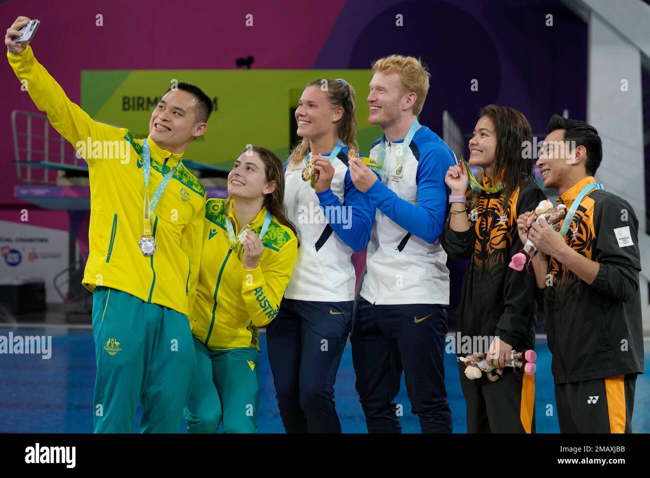 Australia's, sliver medalist Shixin Li, left, takes a photo of his ...