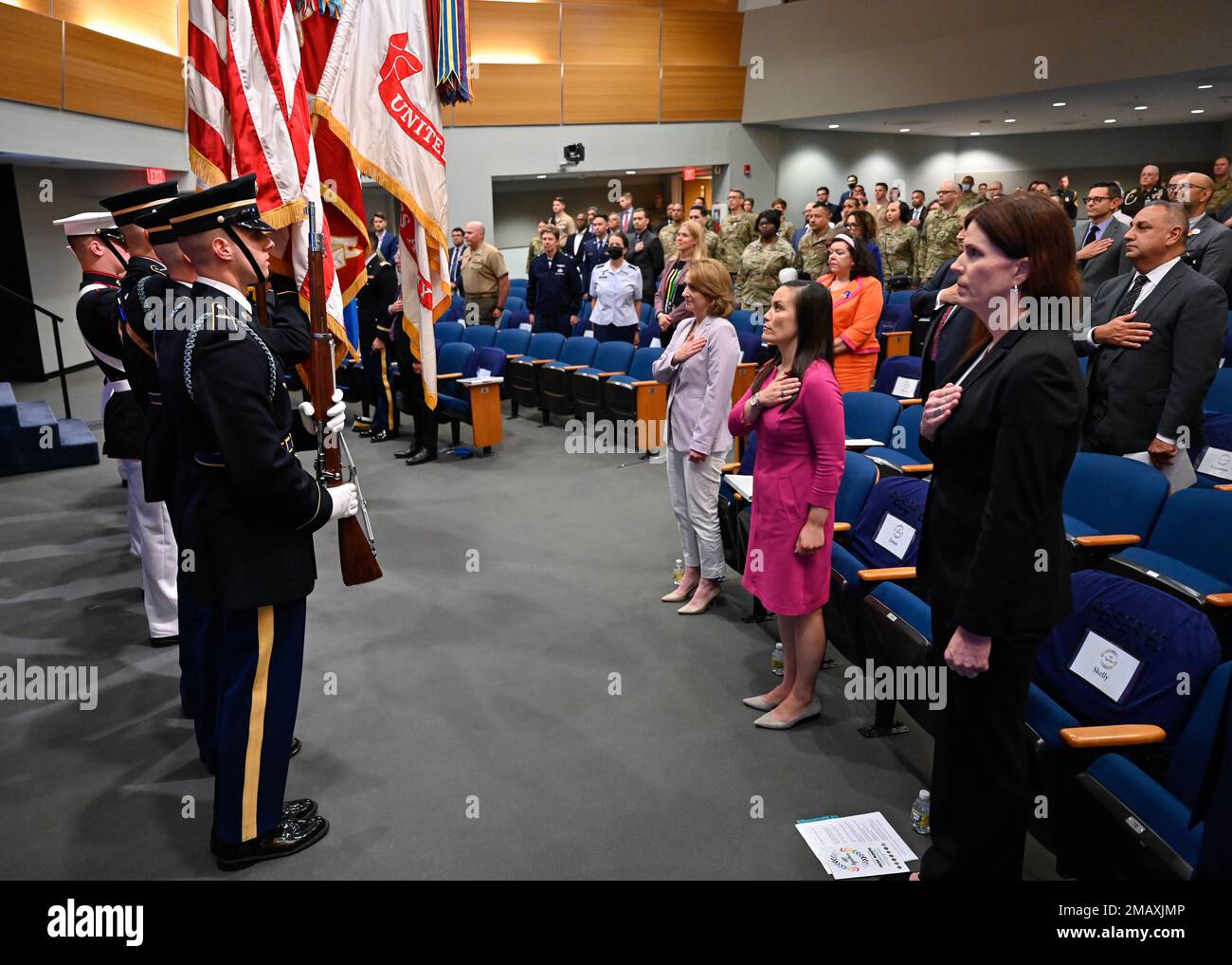 Guests stand for the national anthem during a Department of Defense ...